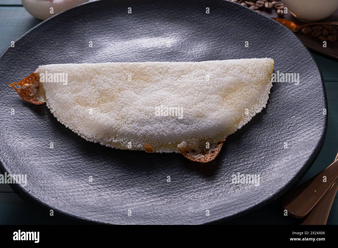 Low key Melted mozzarella cheese tapioca, next to a cup of black coffee ...