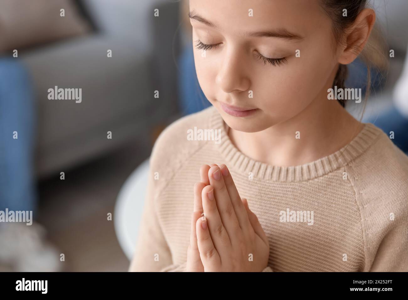 Little girl praying at home, closeup Stock Photo - Alamy