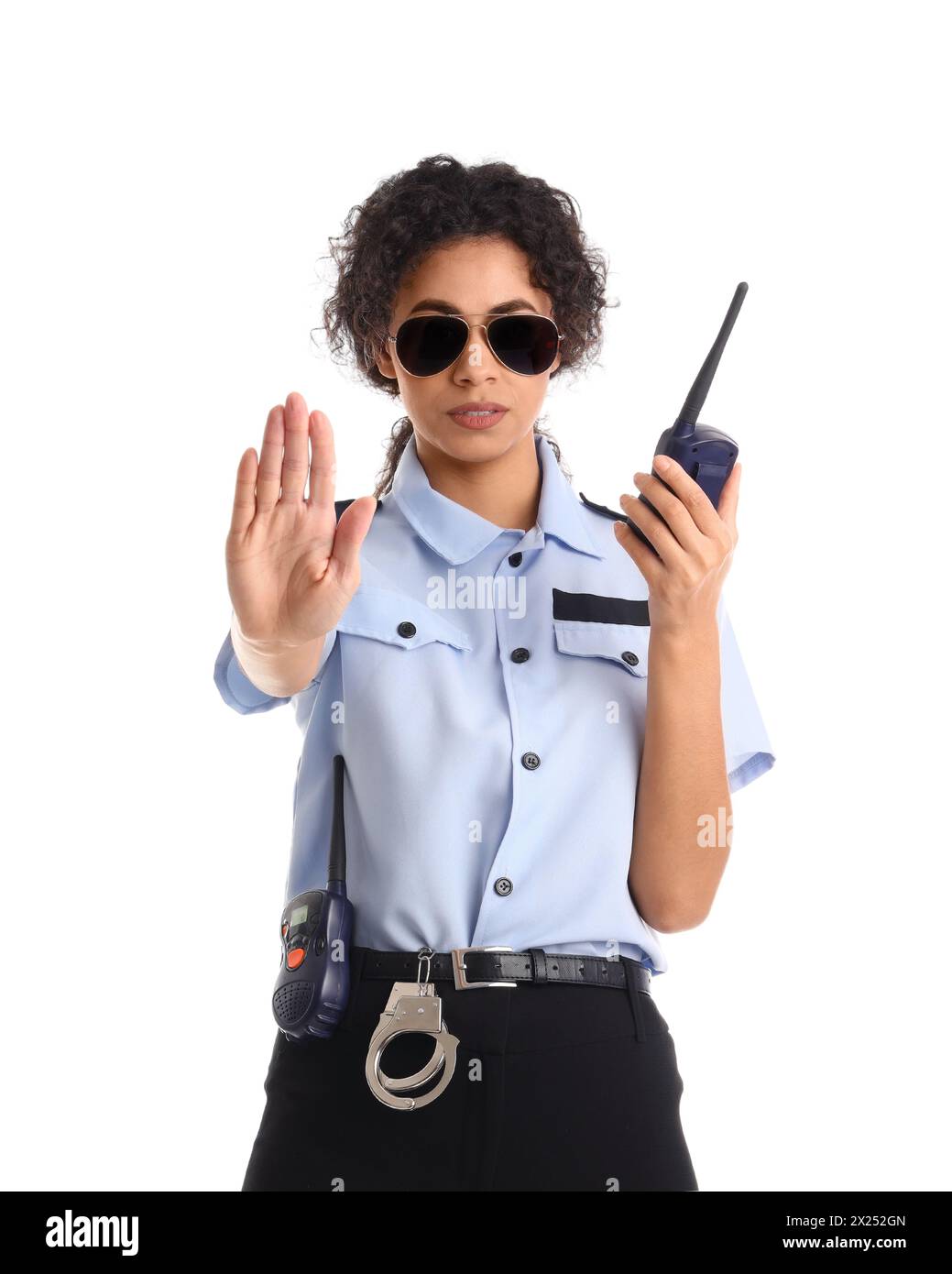 African-American female police officer with radio transmitter showing ...