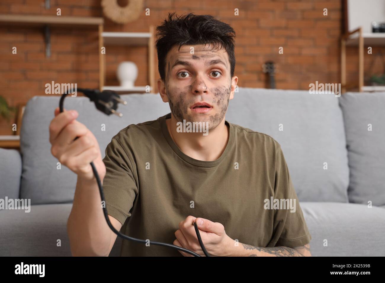 Electrocuted young man with burnt face and plug at home, closeup Stock ...
