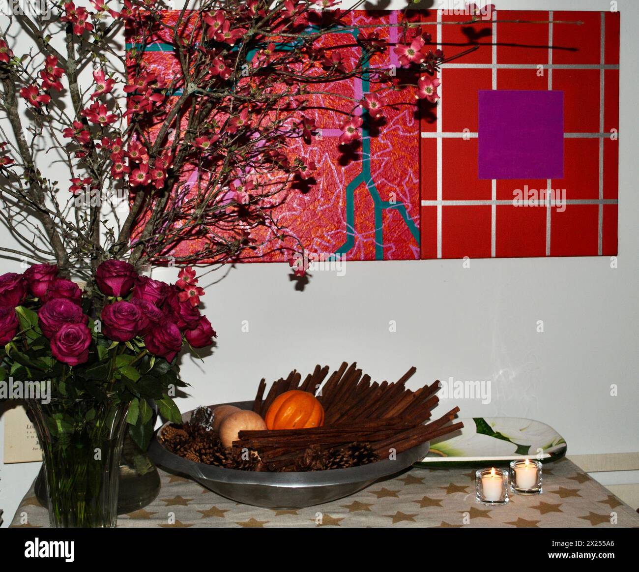 Still life with roses, pink dogwood branches, cinnamon sticks, fruit ...
