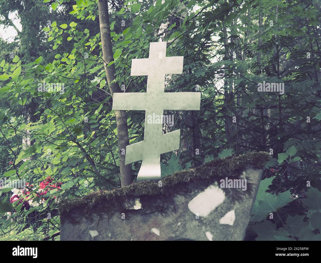 Metal cross on the grave. Monument in the form of a cross in the ...
