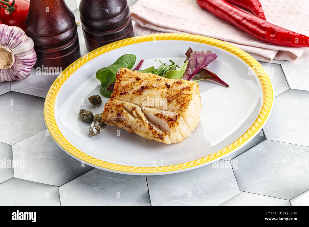Roasted cod fish steak with salad leaves Stock Photo - Alamy