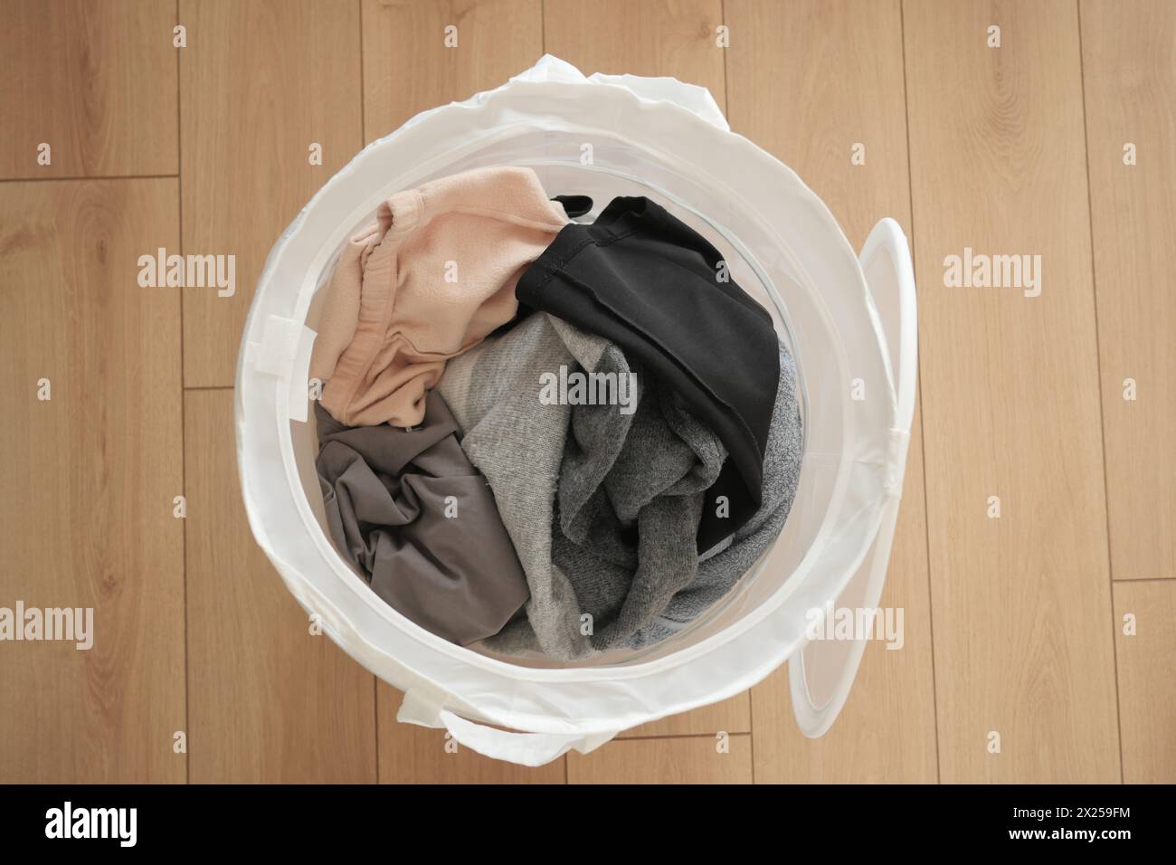 Old clothes thrown into the trash can. Disposal and recycling of ...