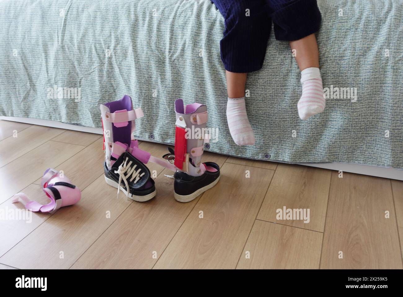 Child cerebral palsy disability, legs orthosis Stock Photo - Alamy