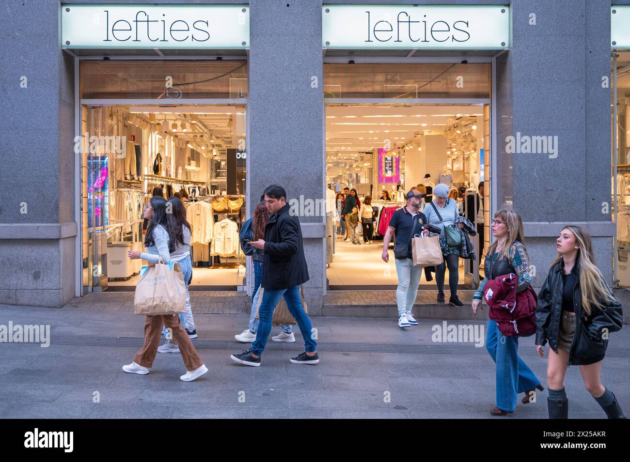 Madrid, Spain. 24th Mar, 2024. Shoppers and pedestrians walk past the ...