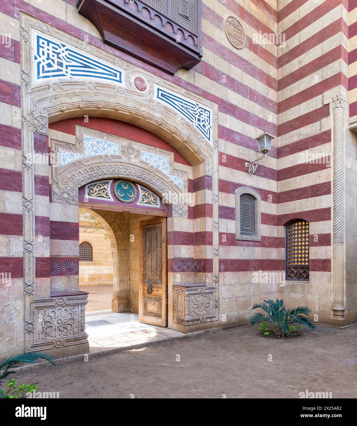 Striking red and white striped arched entrance leads into a Mamluk era ...