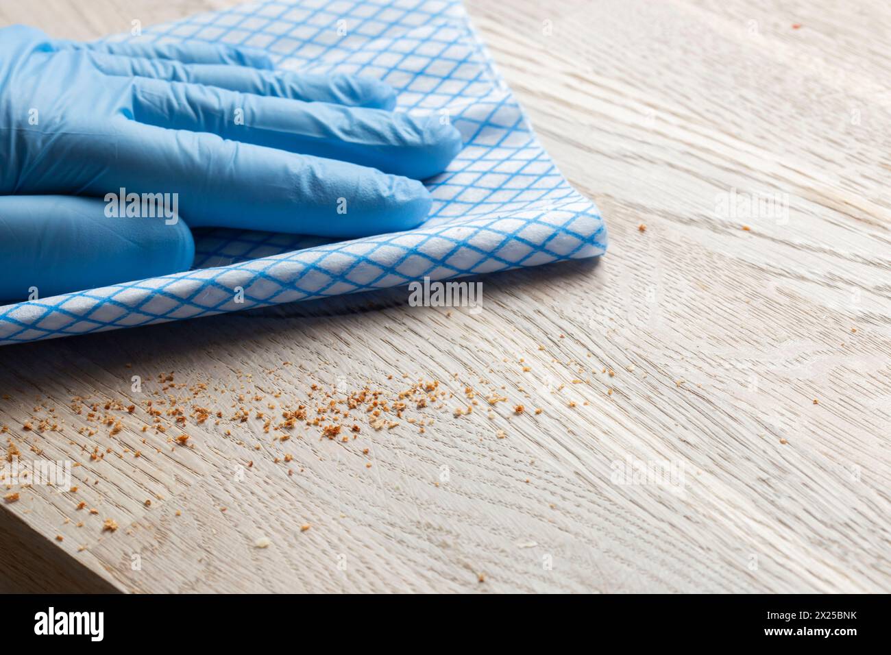 Cleaning wiping wood countertop worktop with a disposable cloth ...
