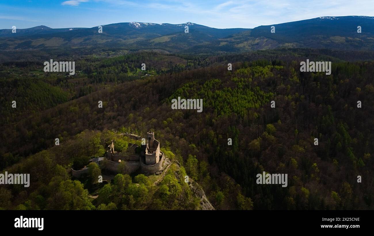 An aerial view captures the medieval Chojnik Castle atop a mountain in ...