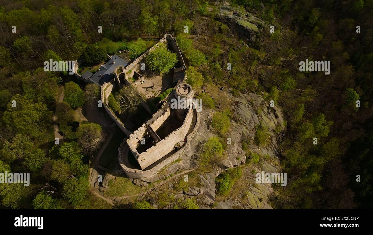 An aerial view captures the medieval Chojnik Castle atop a mountain in ...