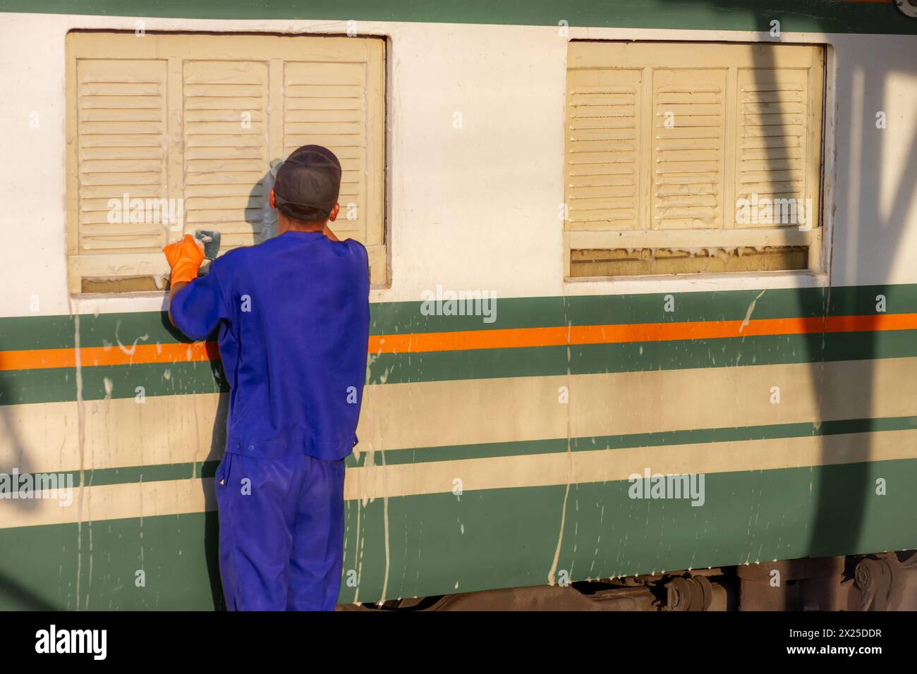 Employees are wiping, washing, inspecting and cleaning trains for use ...