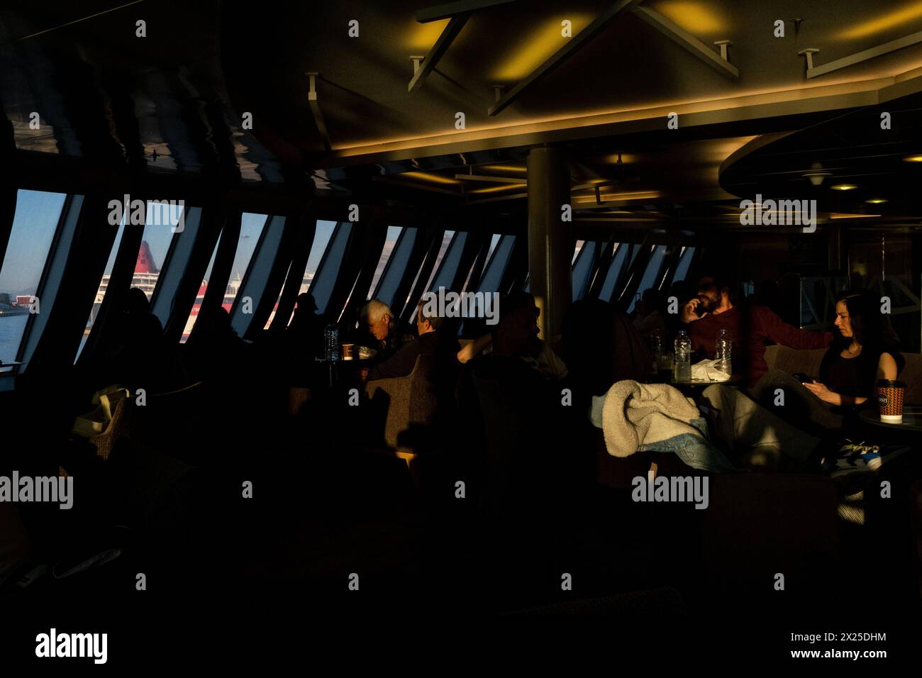 Passenger in the lounge of the Blue Star Ferries boat travelling from ...