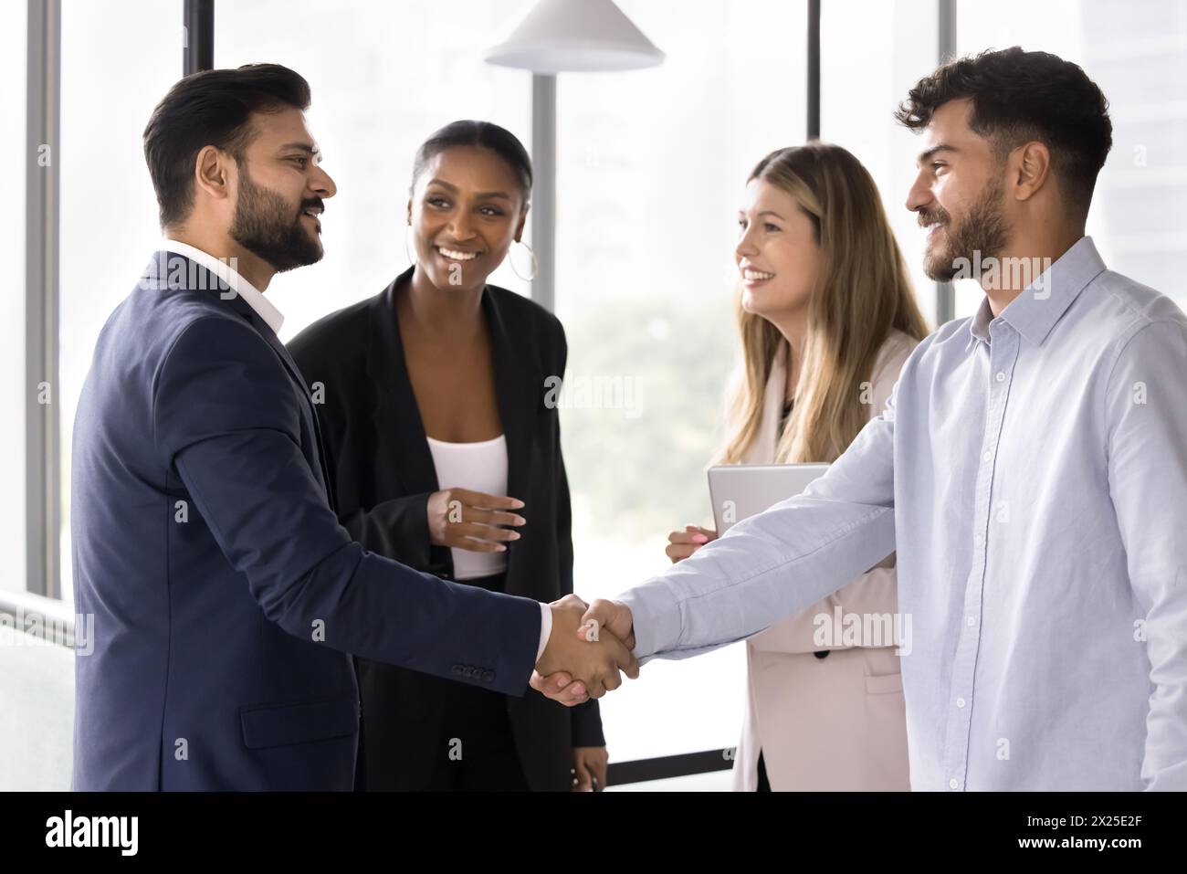 Happy confident diverse male business partners shaking hands Stock ...