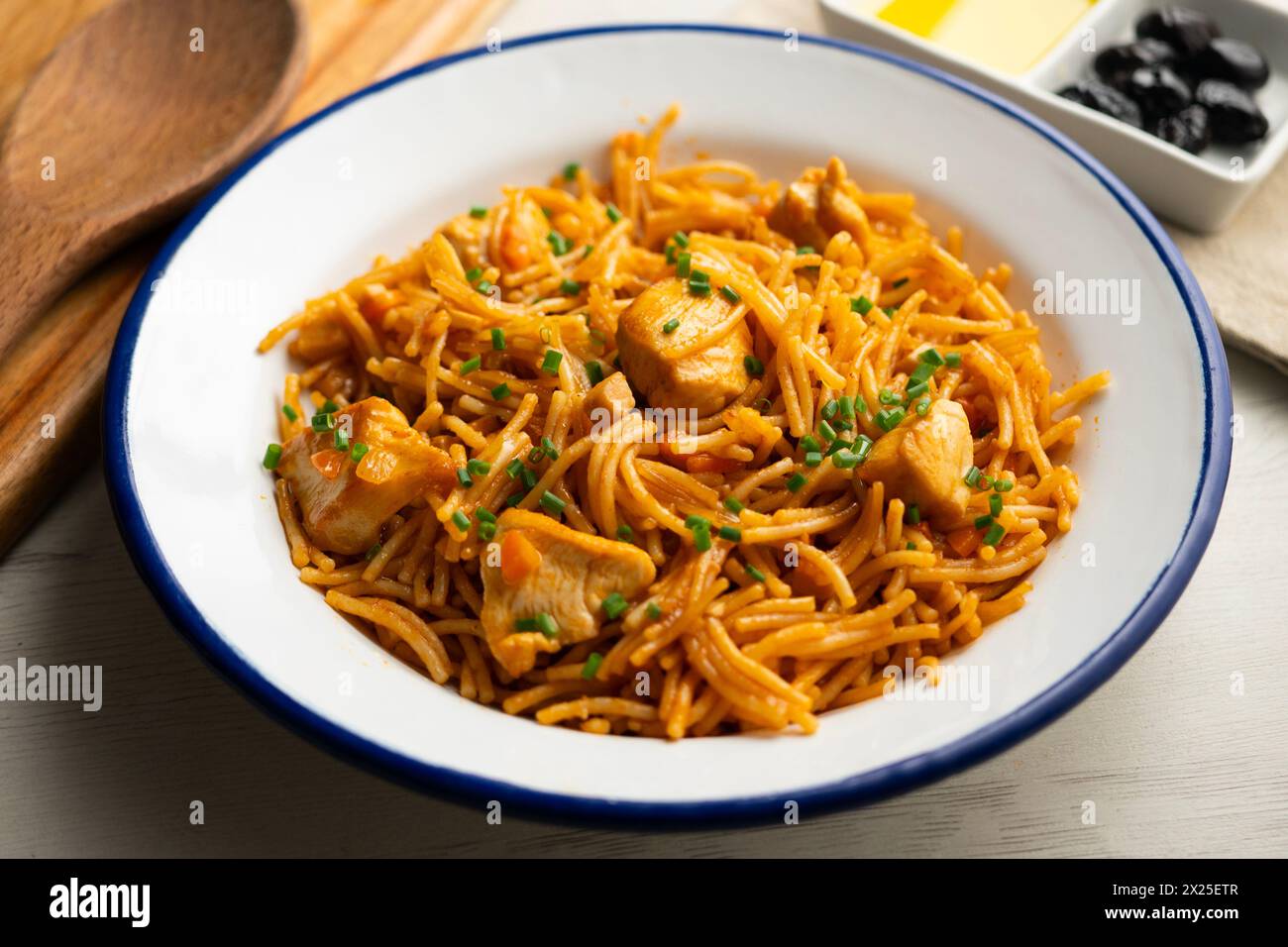 Spanish fideua paella with chicken and vegetables Stock Photo - Alamy