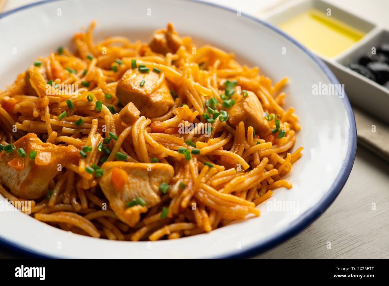 Spanish fideua paella with chicken and vegetables Stock Photo - Alamy