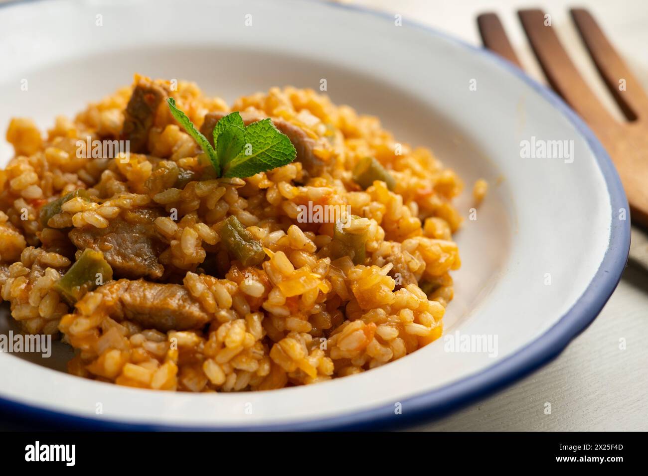 Spanish rice paella with Iberian pork loin Stock Photo - Alamy