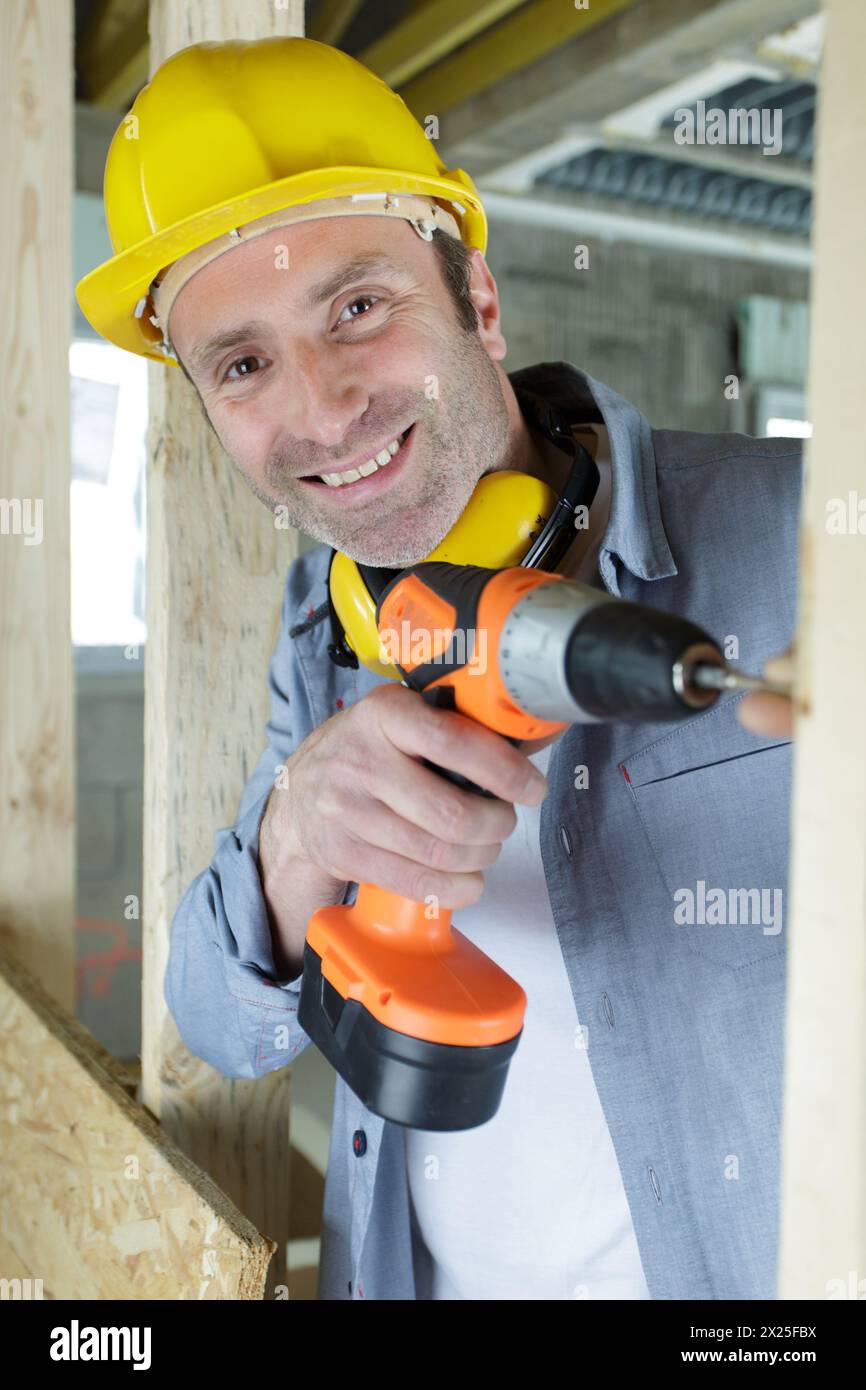 happy man drilling the wall with drill perforator Stock Photo - Alamy