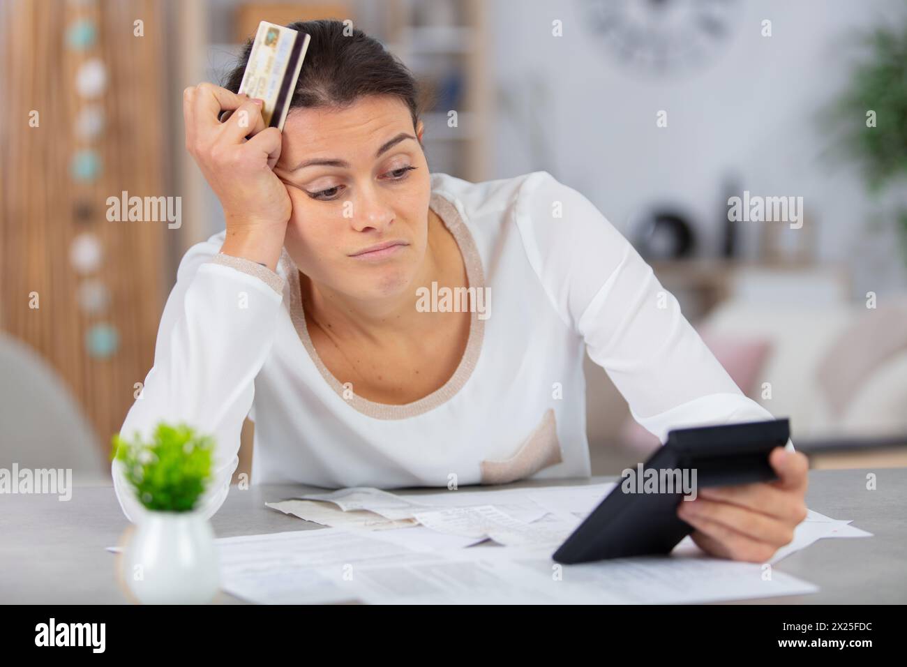 Desperate woman looking papers hi-res stock photography and images - Alamy