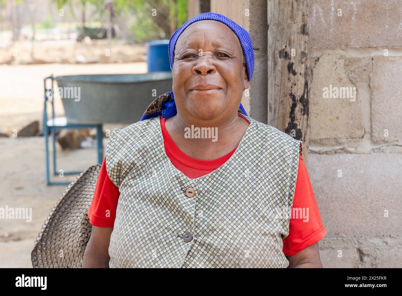 old african woman in the village sited on a chair in her yard Stock ...