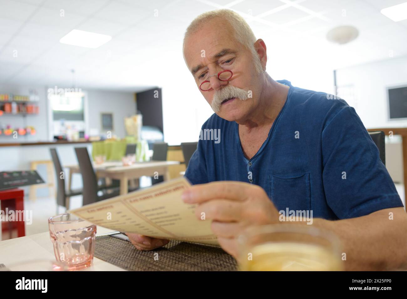 Senior man reading menu hi-res stock photography and images - Alamy