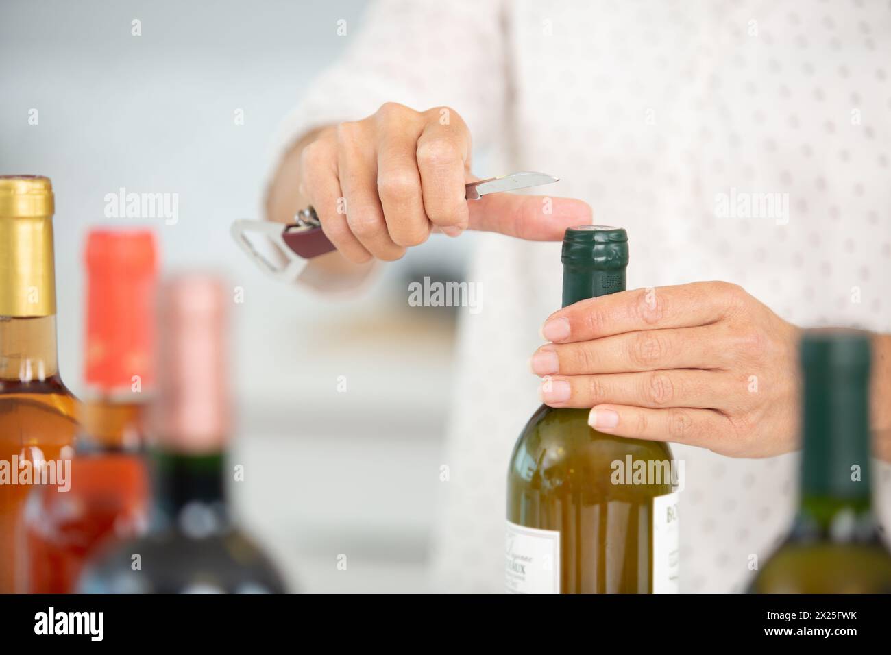 hand broaching bottles of wine Stock Photo - Alamy