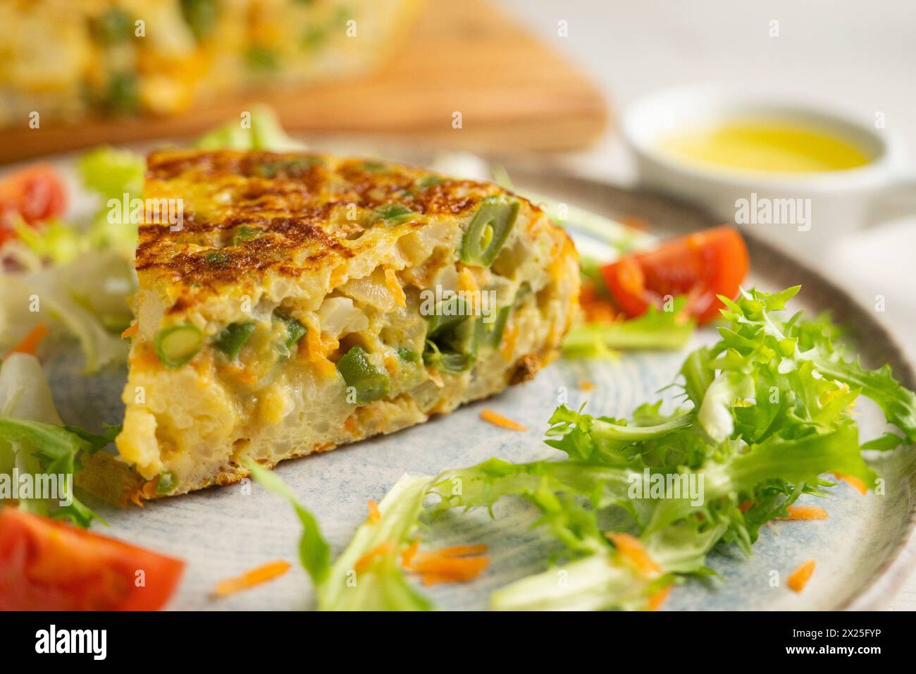 Spanish potato omelet with cauliflower and vegetables. Traditional ...