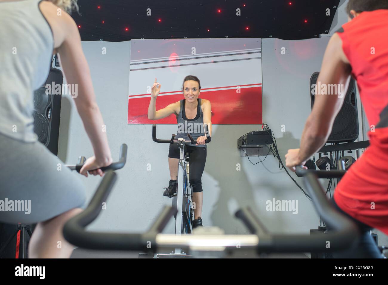 a woman teaches spinning class Stock Photo - Alamy