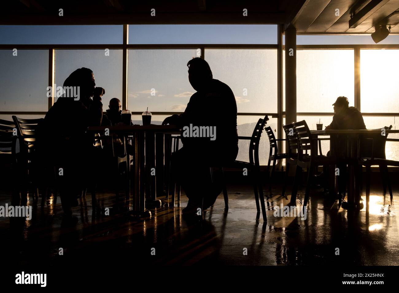 Passengers drinking a coffee ice cream on the terrace of the Blue Star ...