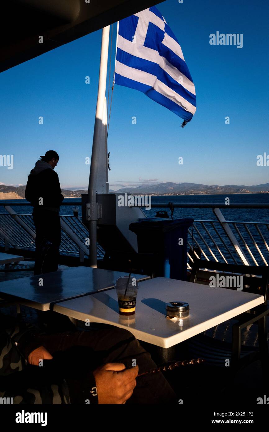 Passenger drinking a coffee with ice cream and a Greek flag on the ...
