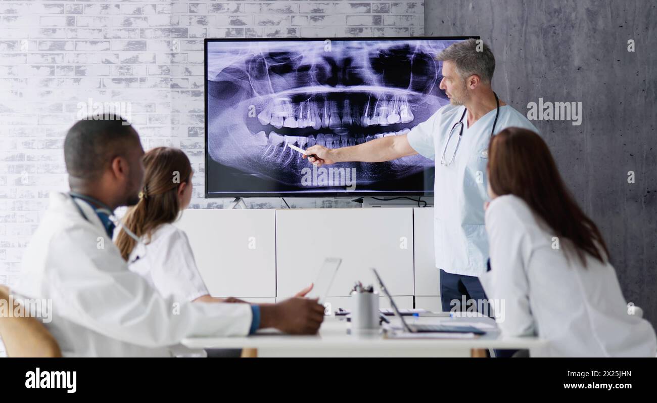Group of dental doctors at conference meeting watching TV Stock Photo ...