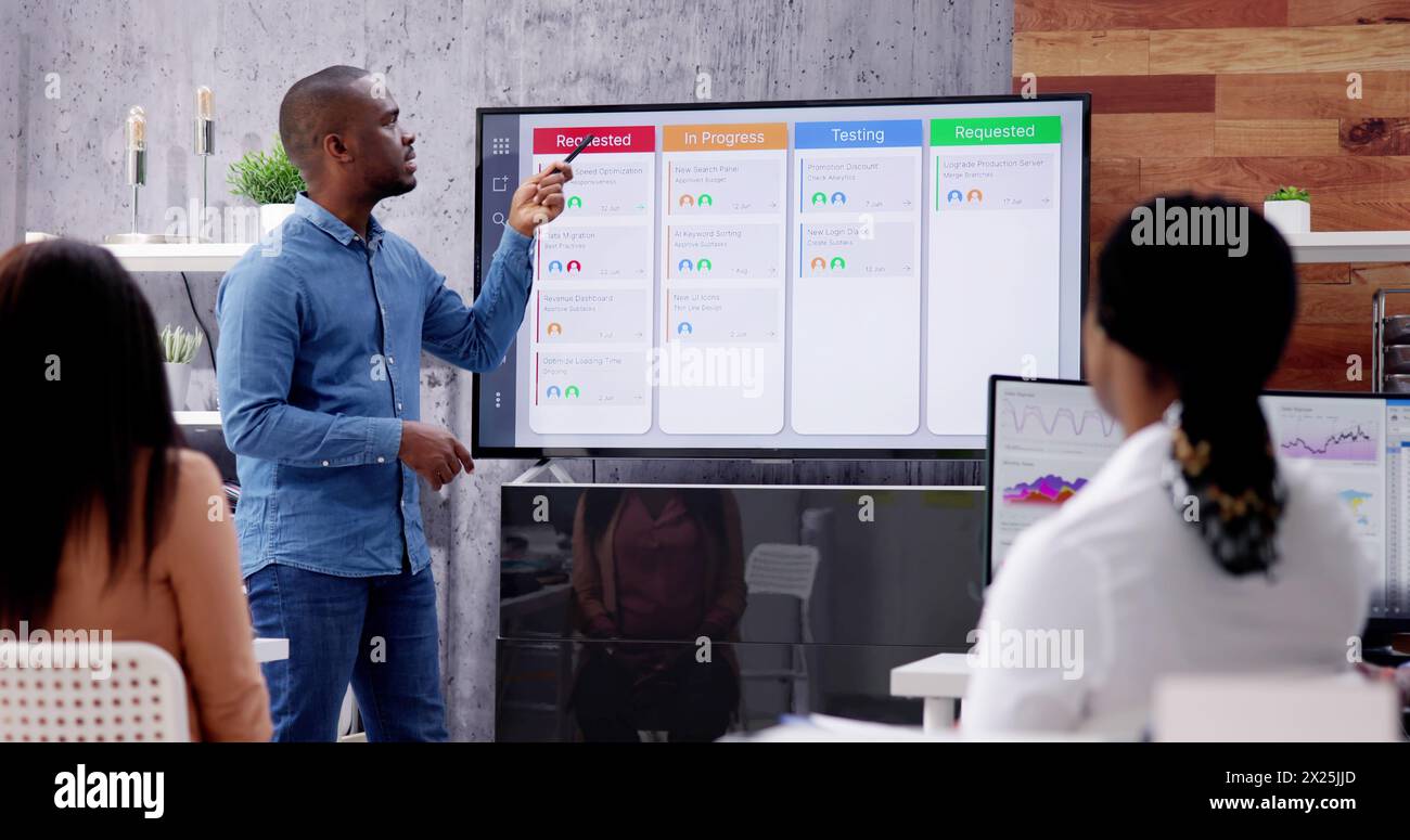 Corporate training in a black classroom with computer background Stock ...