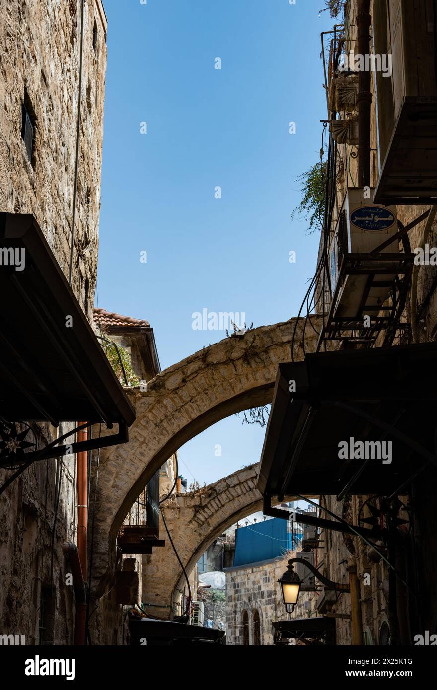 A narrow street among stone houses in old Jerusalem, Israel. High ...