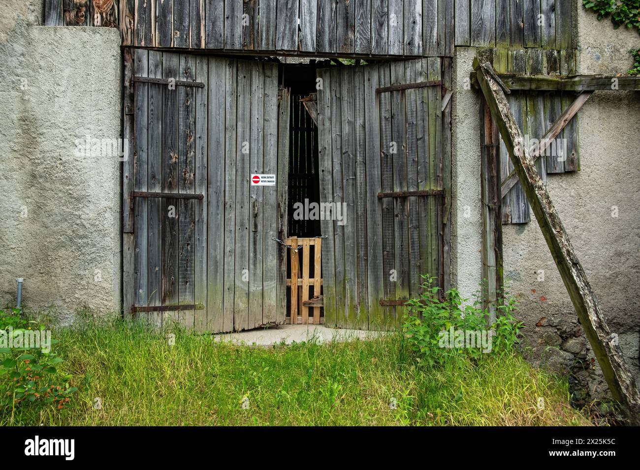 Weathered wooden barn gate with a NO ACCESS sign on a hiking trail ...