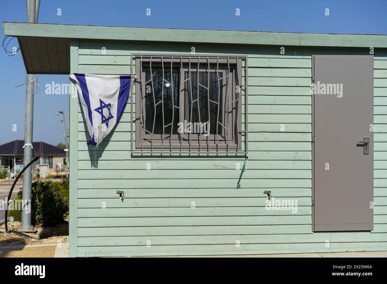 Security booth with barred window and Israel flag at the entrance of a ...