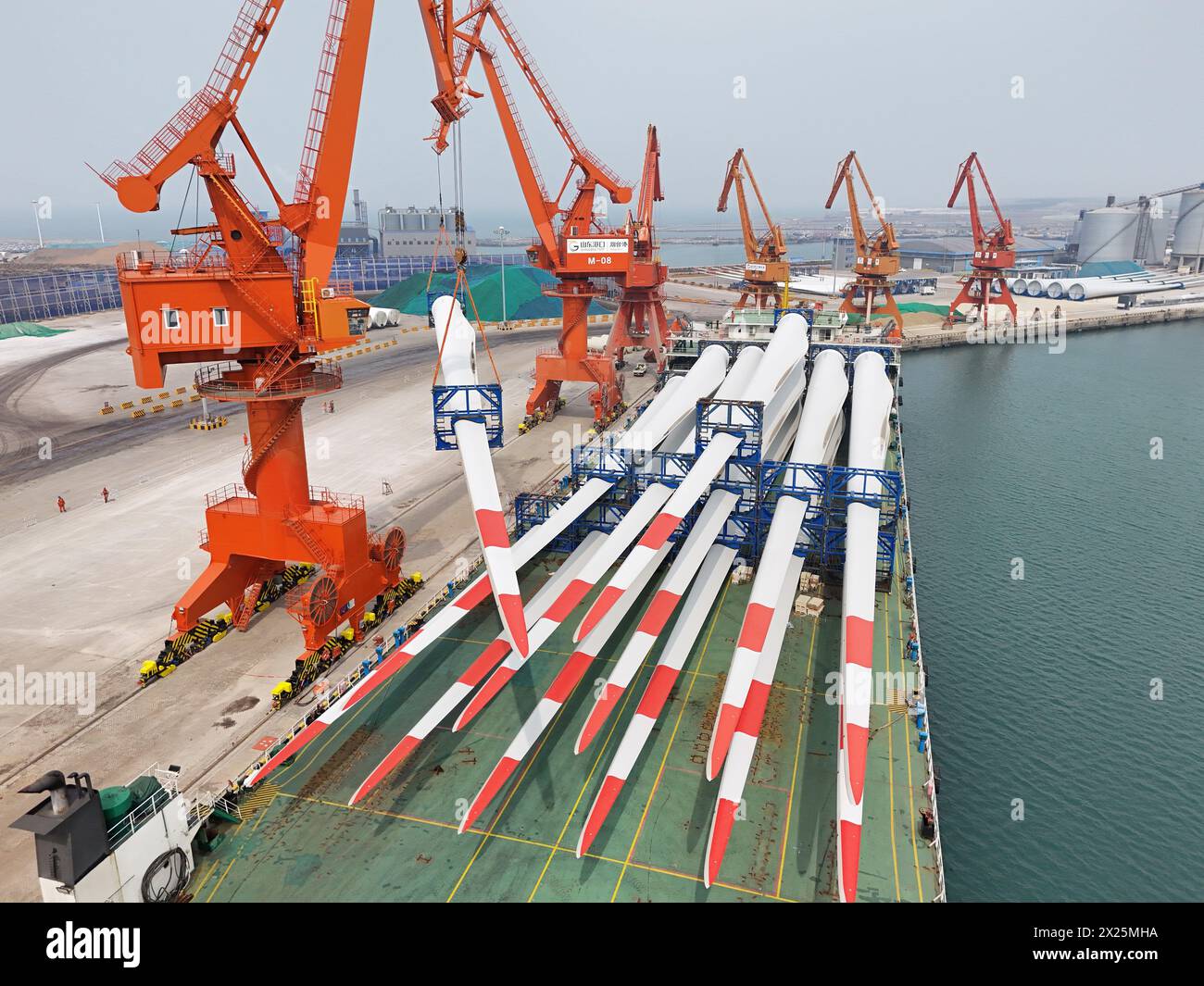 YANTAI, CHINA - APRIL 19, 2024 - A crane loads offshore wind turbine ...