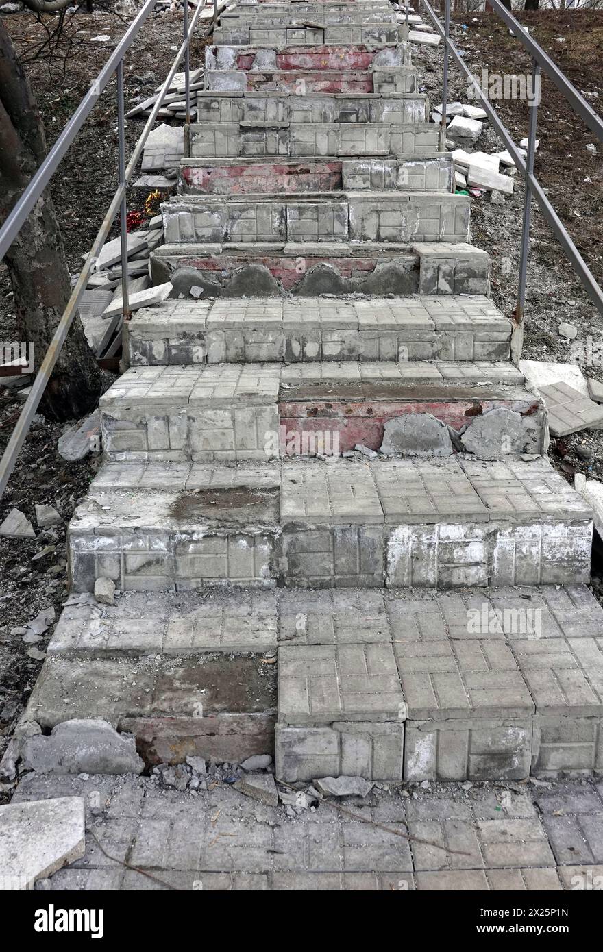 Dismantling damaged old steps on stone ladder with handrails during ...
