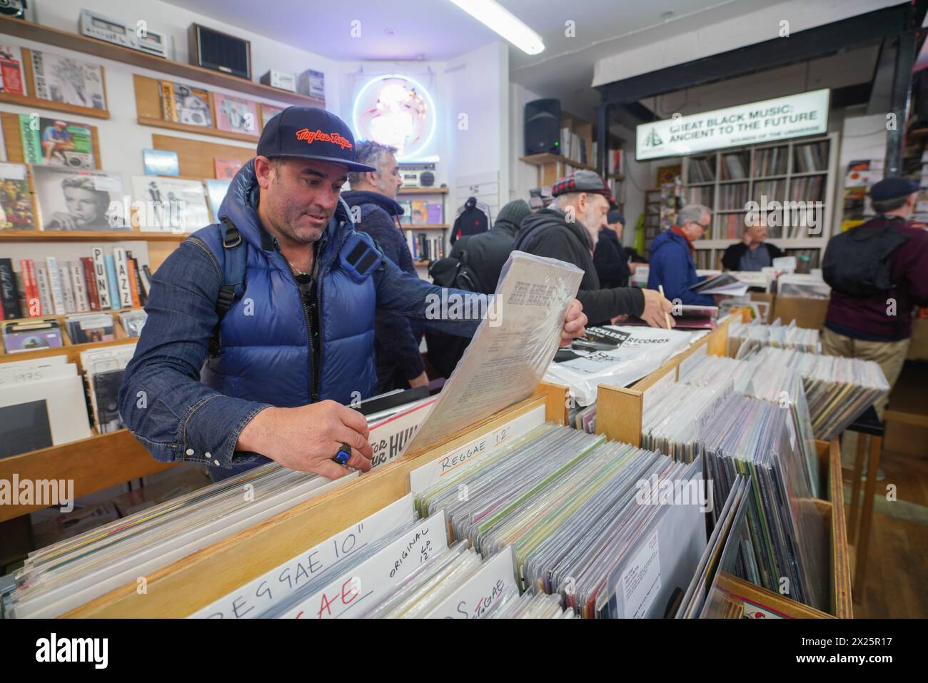 London 20 April 2024 . A man browses vinyl records inside 'Sounds of the Universe' store in Soho ...