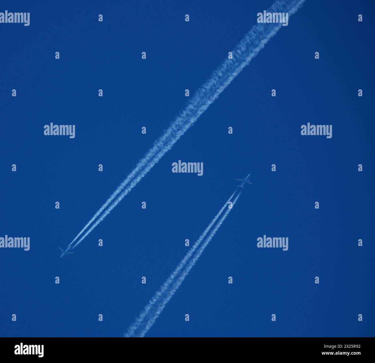 two planes in the sky, two parallel airplane tracks in the blue sky ...