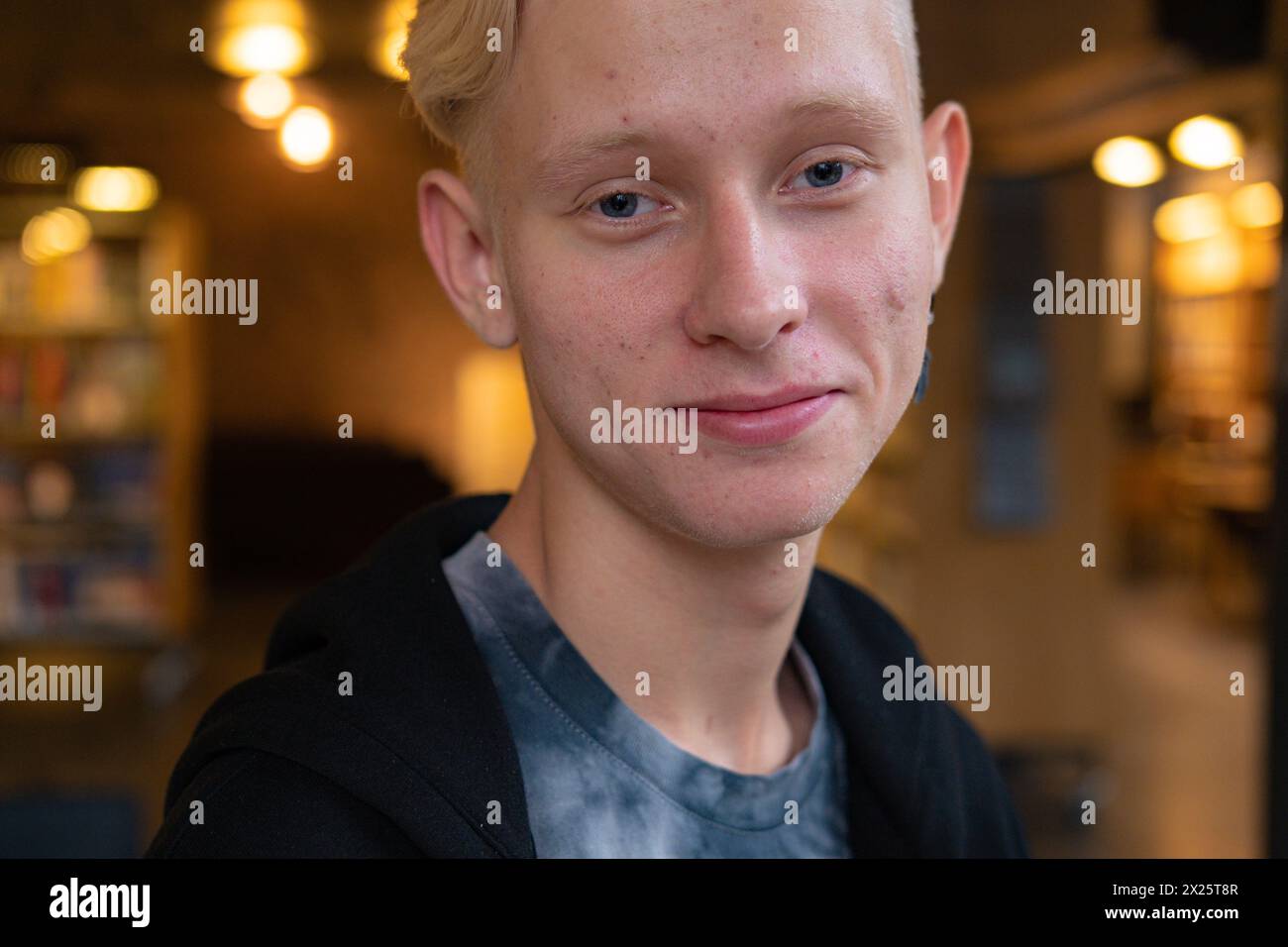 a smiling guy smiles lightly at the camera. Modern education of young ...