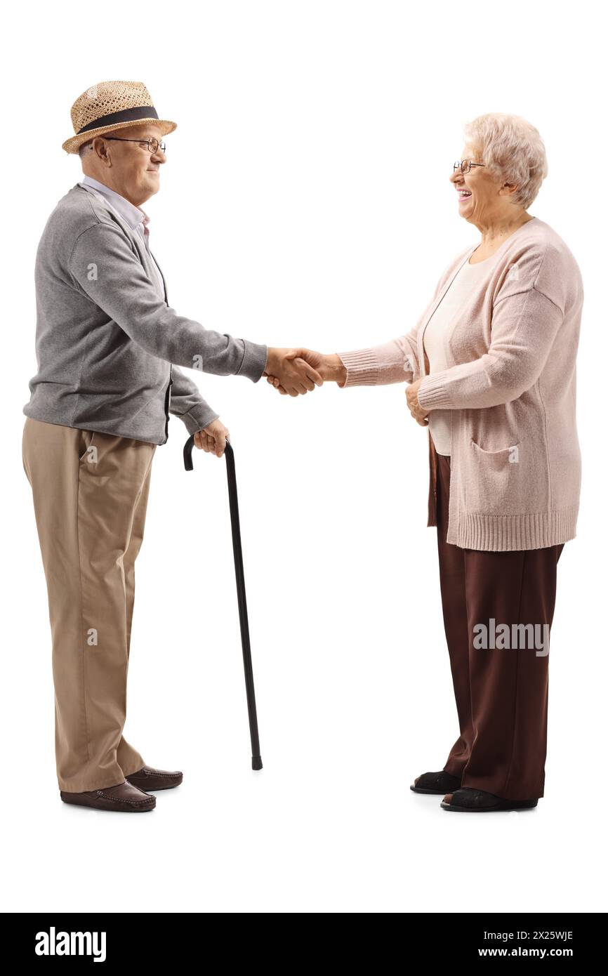 Full length profile shot of an elderly man and an elderly woman shaking ...