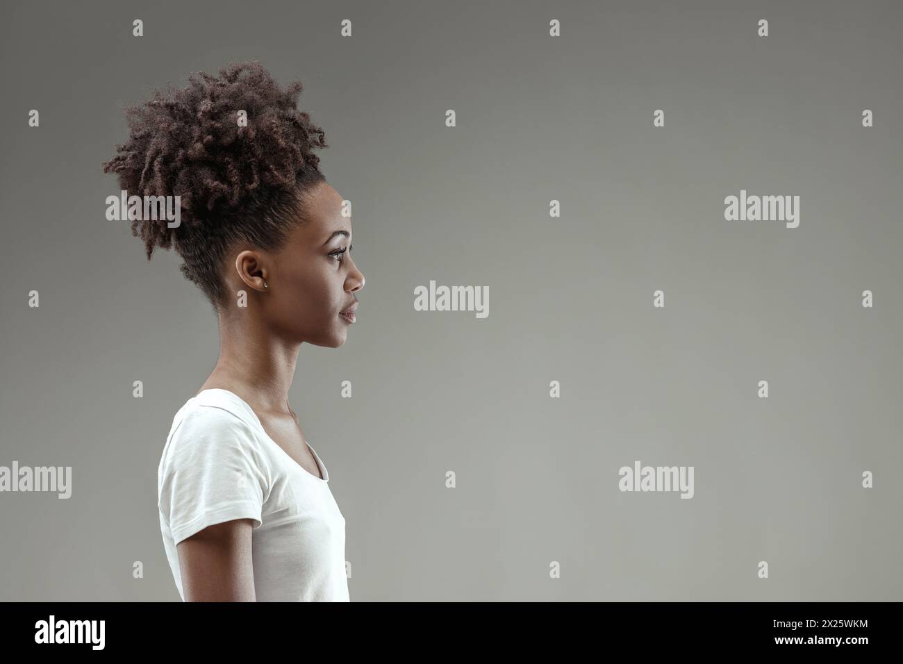 Profile of a young woman attentively listening, her expression focused ...