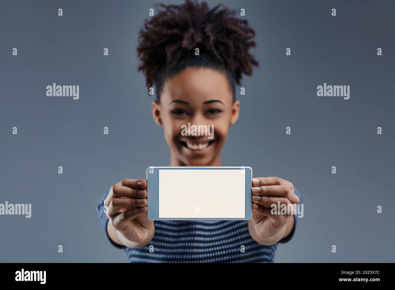Enthusiastically holding a smartphone, the woman's cheerful demeanor ...