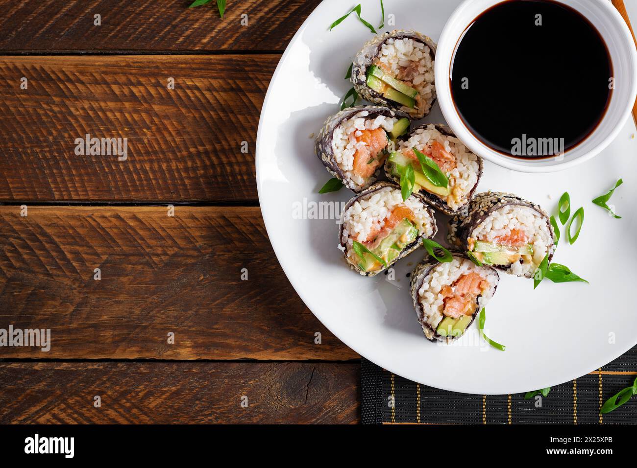Spring roll with nori, sushi rice, salmon, cucumber and avocado, sriracha and sesame mayonnaise ...