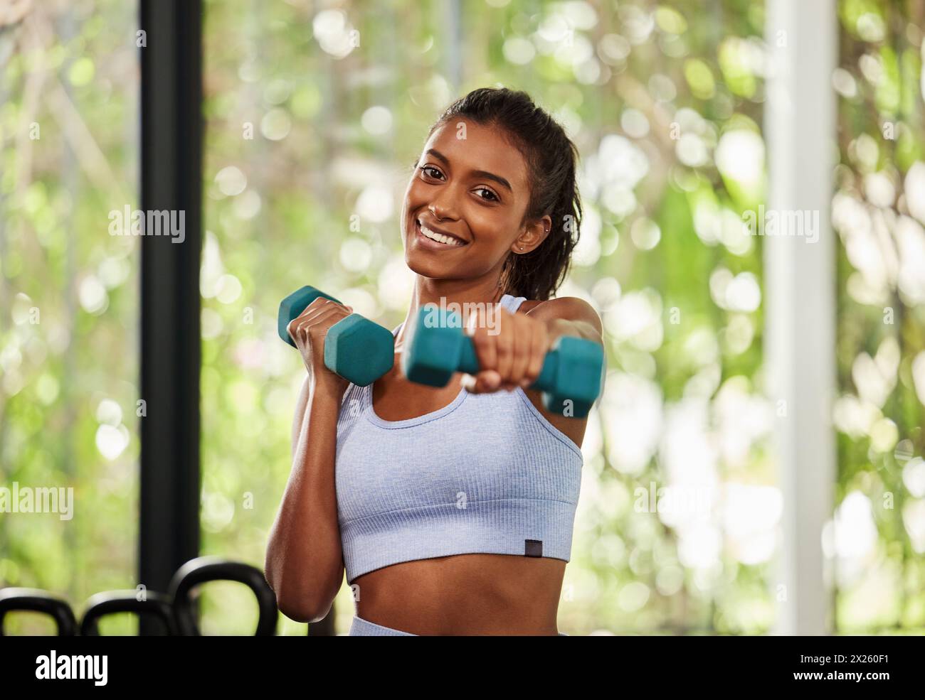 Indian girl, portrait and dumbbells for workout at gym, bicep and ...