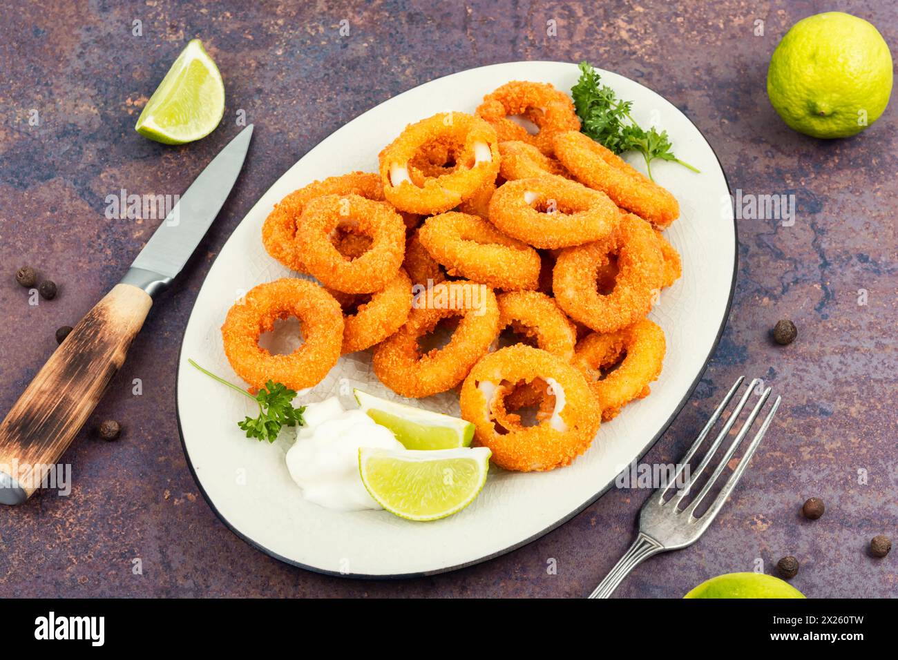 Baked breaded calamari or octopus rings on brown concrete table Stock ...