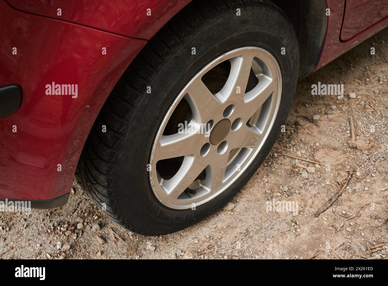 Old car tire wheel with aluminum alloy rim wheel on gravel ready for ...