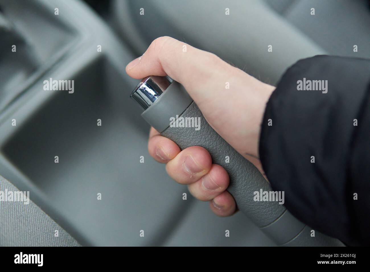 Man holding and pulling handbrake handle emergency parking e-brake in ...