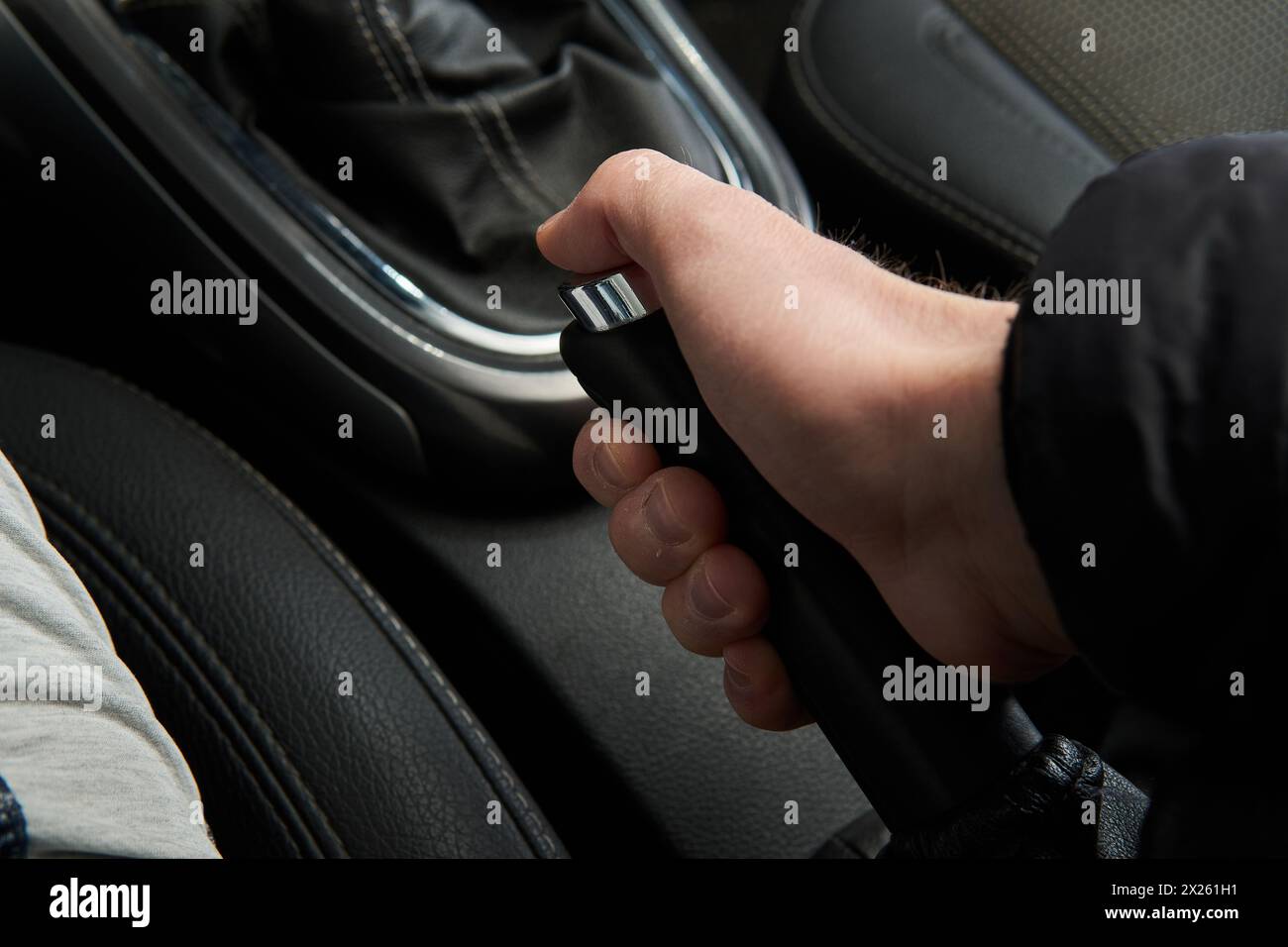 Man holding and pulling handbrake handle emergency parking e-brake in ...