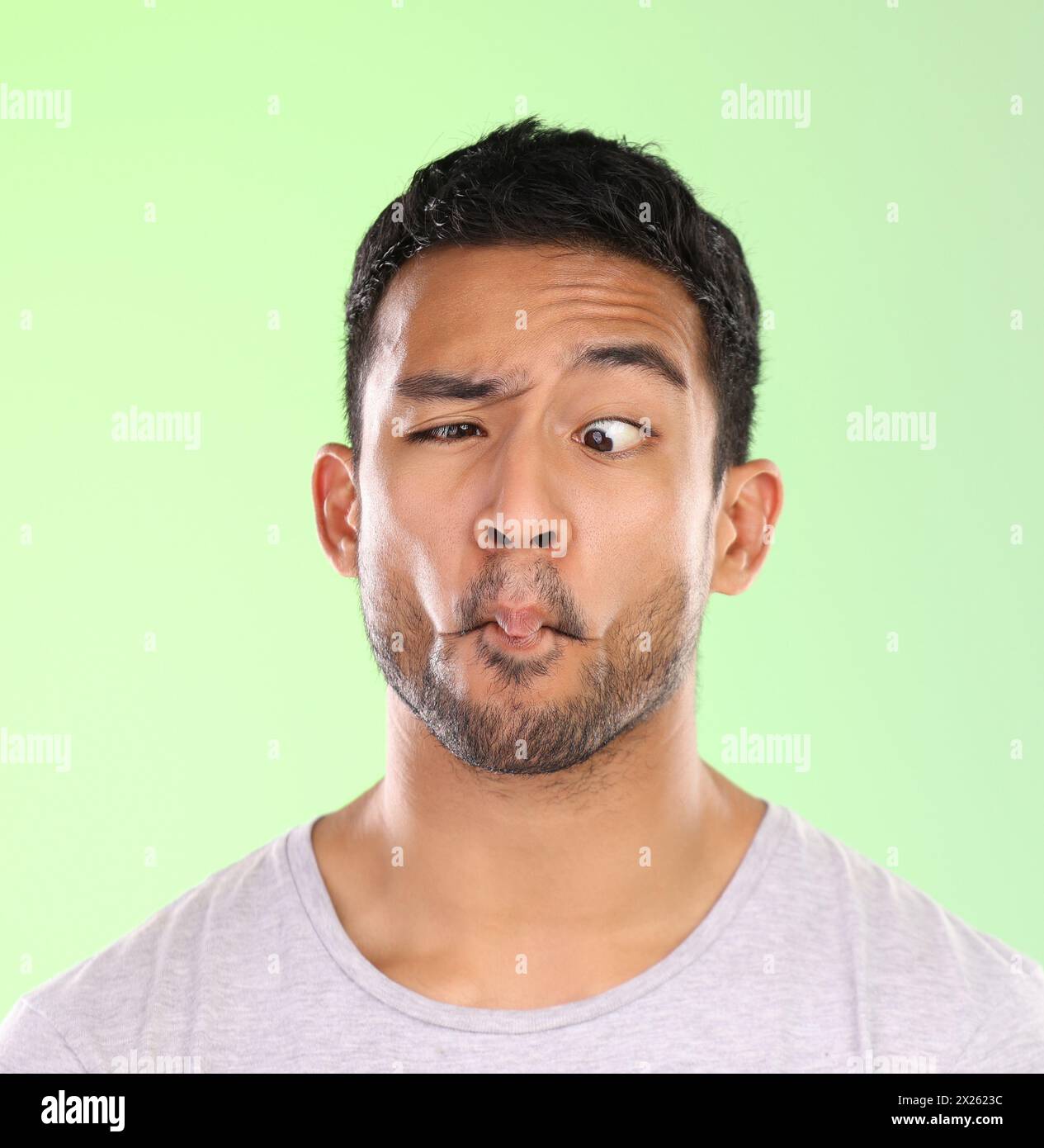 Man, funny and comic face in studio with silly, goofy and emoji mouth ...