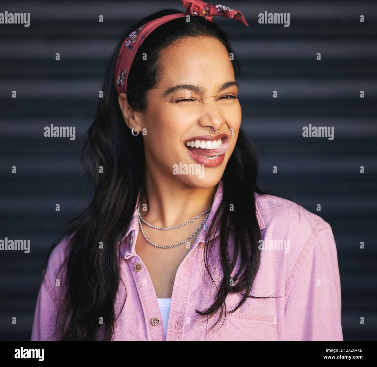Portrait, girl and wink with tongue, smile and outdoor for fashion ...